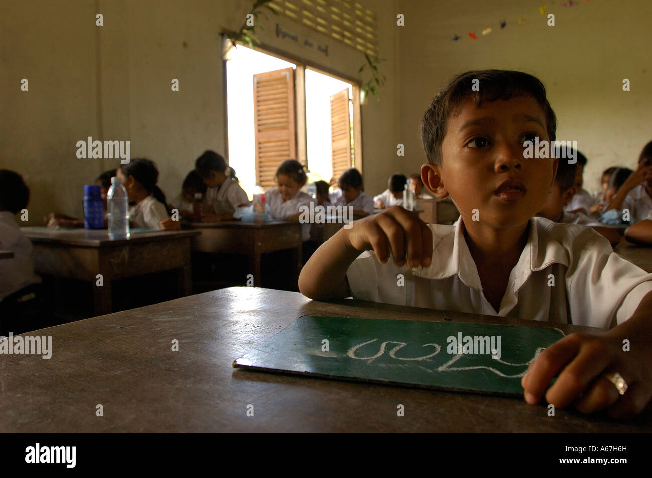 Khmer school children are studying in their classroom at the small Sras ...
