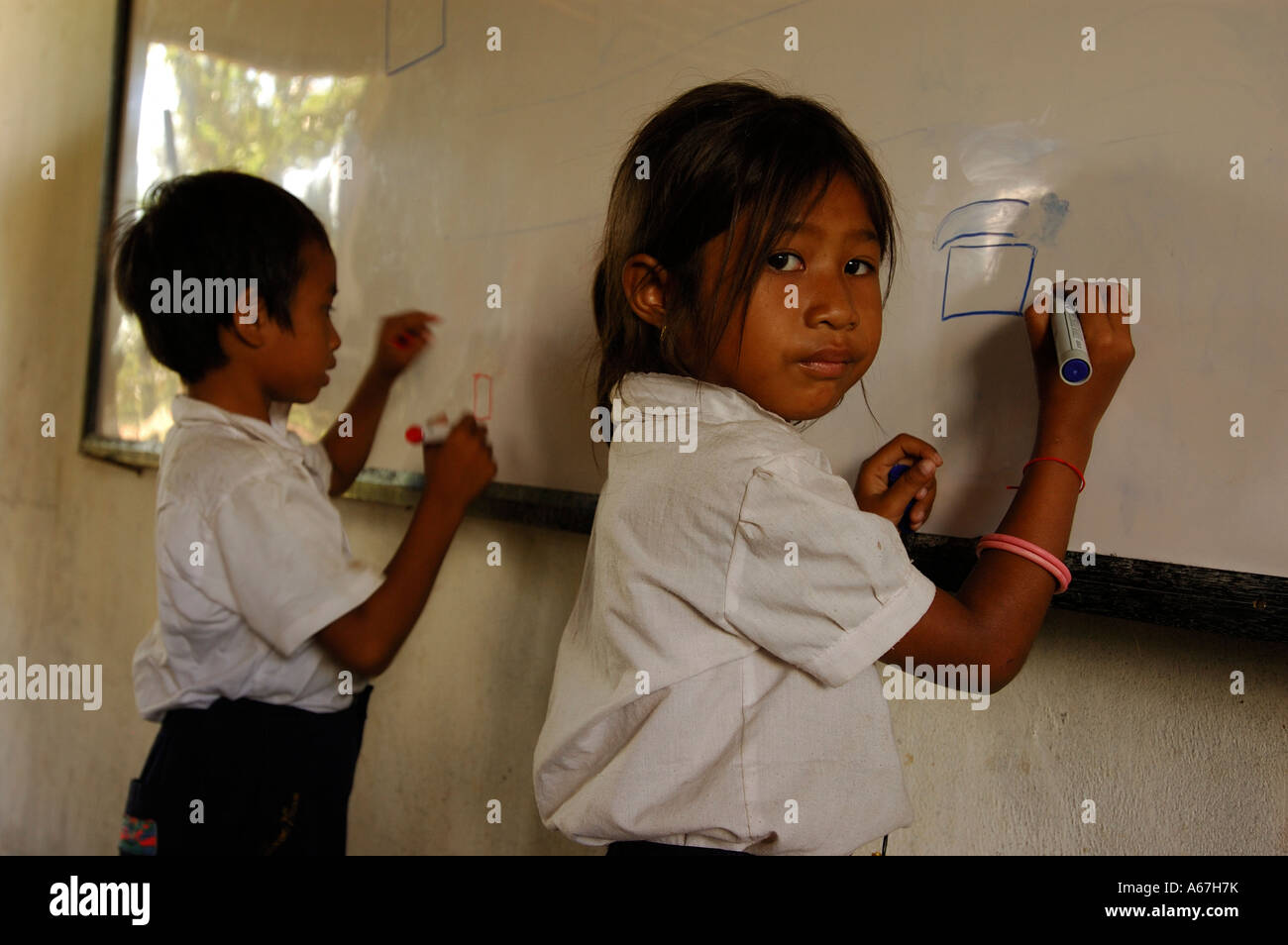 Khmer school children are studying in their classroom at the small Sras ...