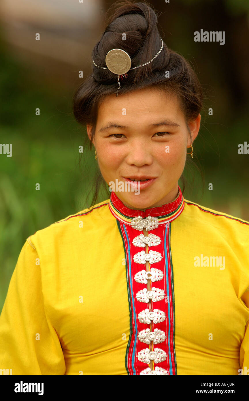 Portrait of a Tai Dam indigenous woman in a yellow traditional dress ...