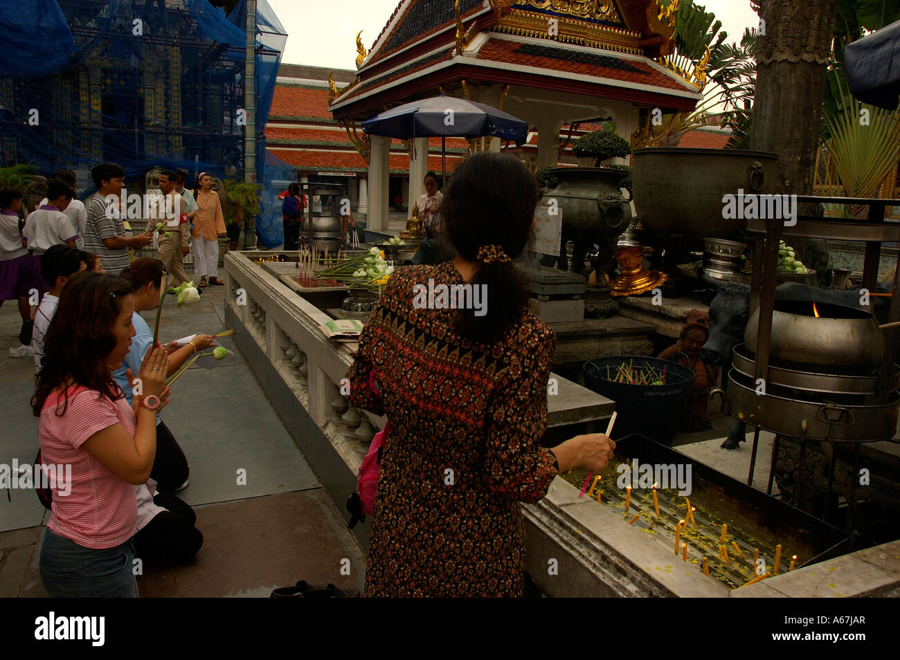 Buddhist worshippers give offerings and pray at the Wat Sapaya temple ...