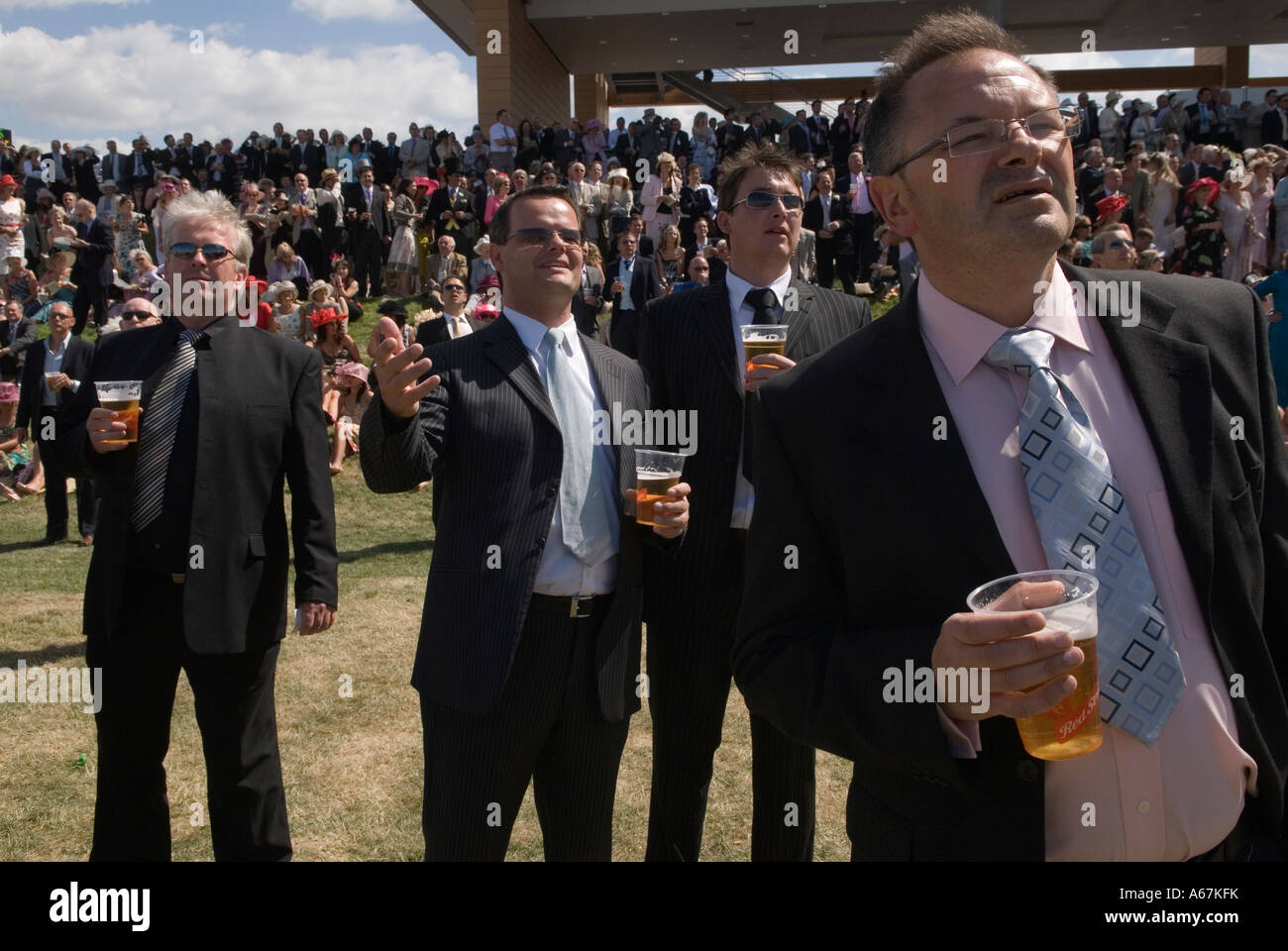 Group of men drinking beer Ascot horse racing gesturing watching horse ...