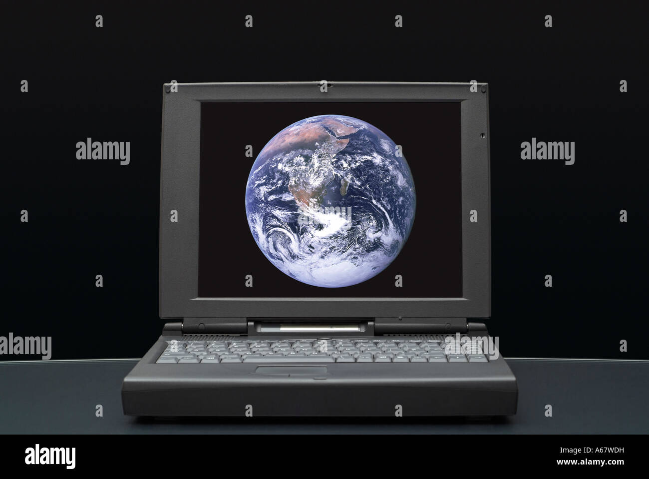 Laptop Computer with Planet Earth Displayed on the Screen Against a ...