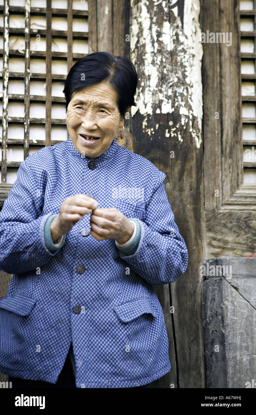 CHINA ChuanDiXia Elderly female owner of a guest house wearing ...