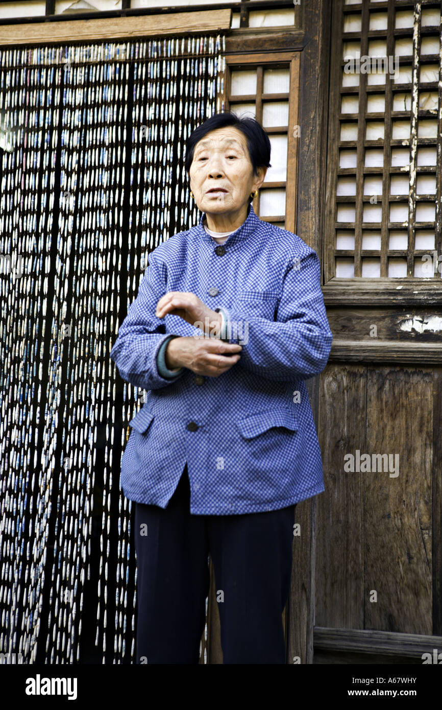 CHINA ChuanDiXia Elderly female owner of a guest house wearing ...