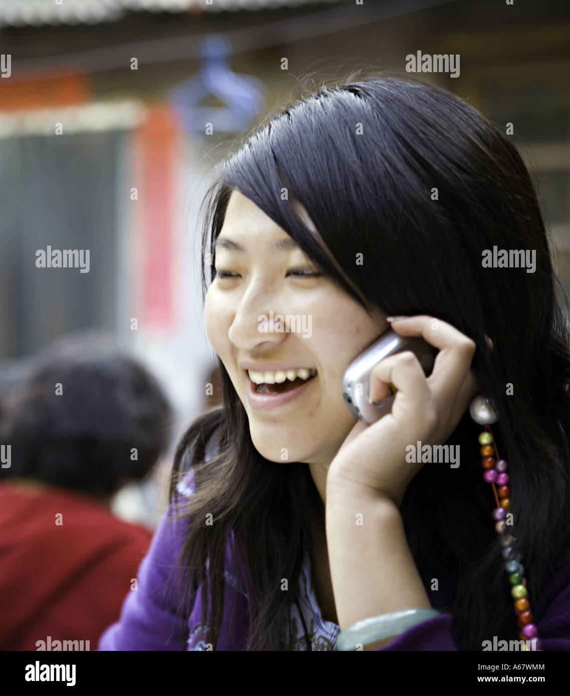 CHINA Chuandixia Modern young Chinese woman talking on her cell phone ...