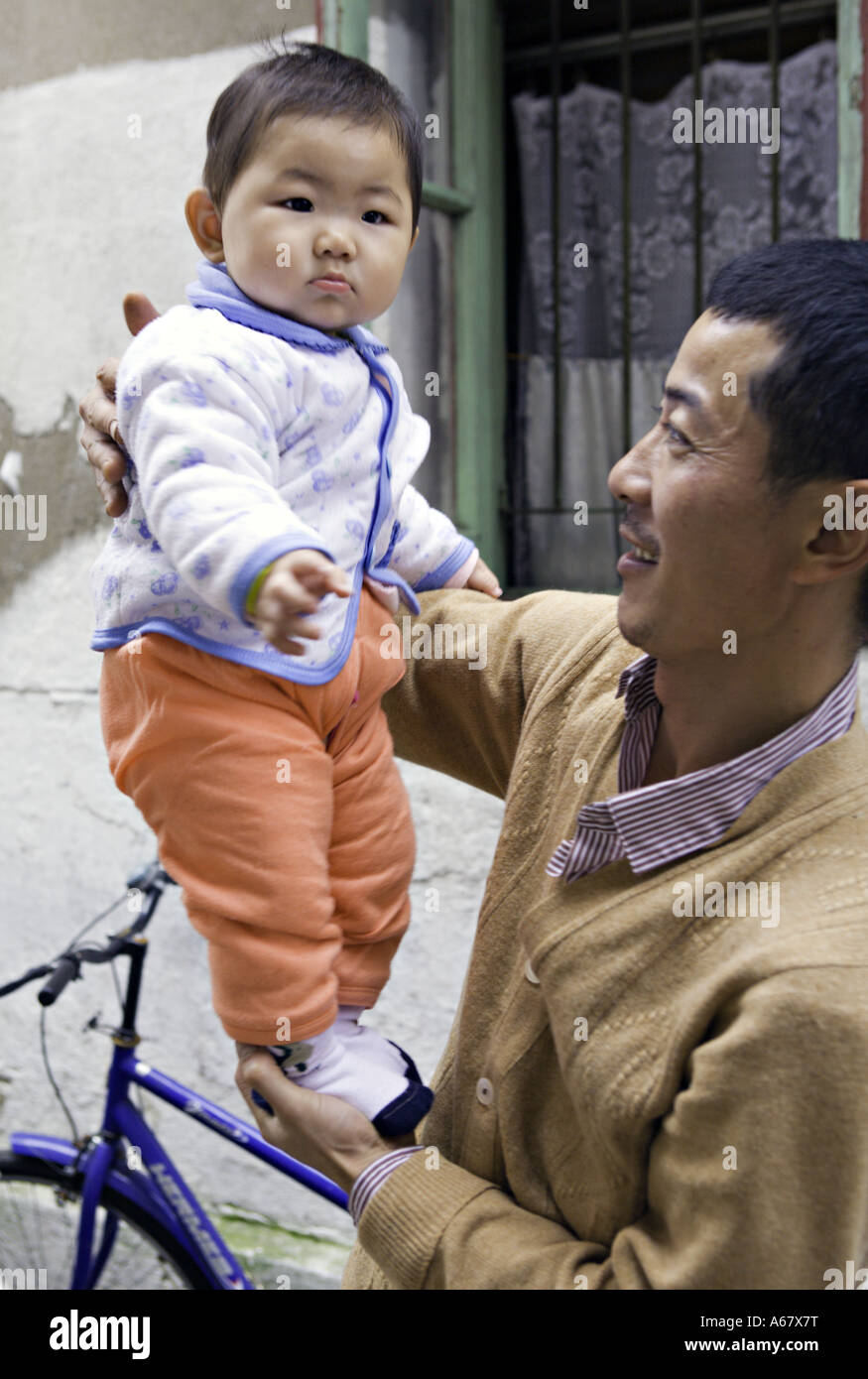 CHINA SHANGHAI Proud young Chinese father shows off his baby son on a ...