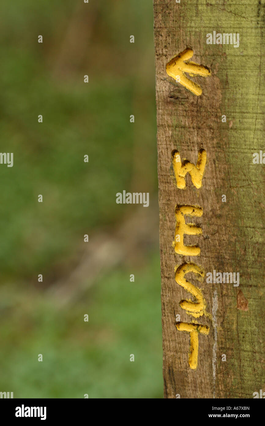 Footpath direction sign pointing to West Stock Photo - Alamy