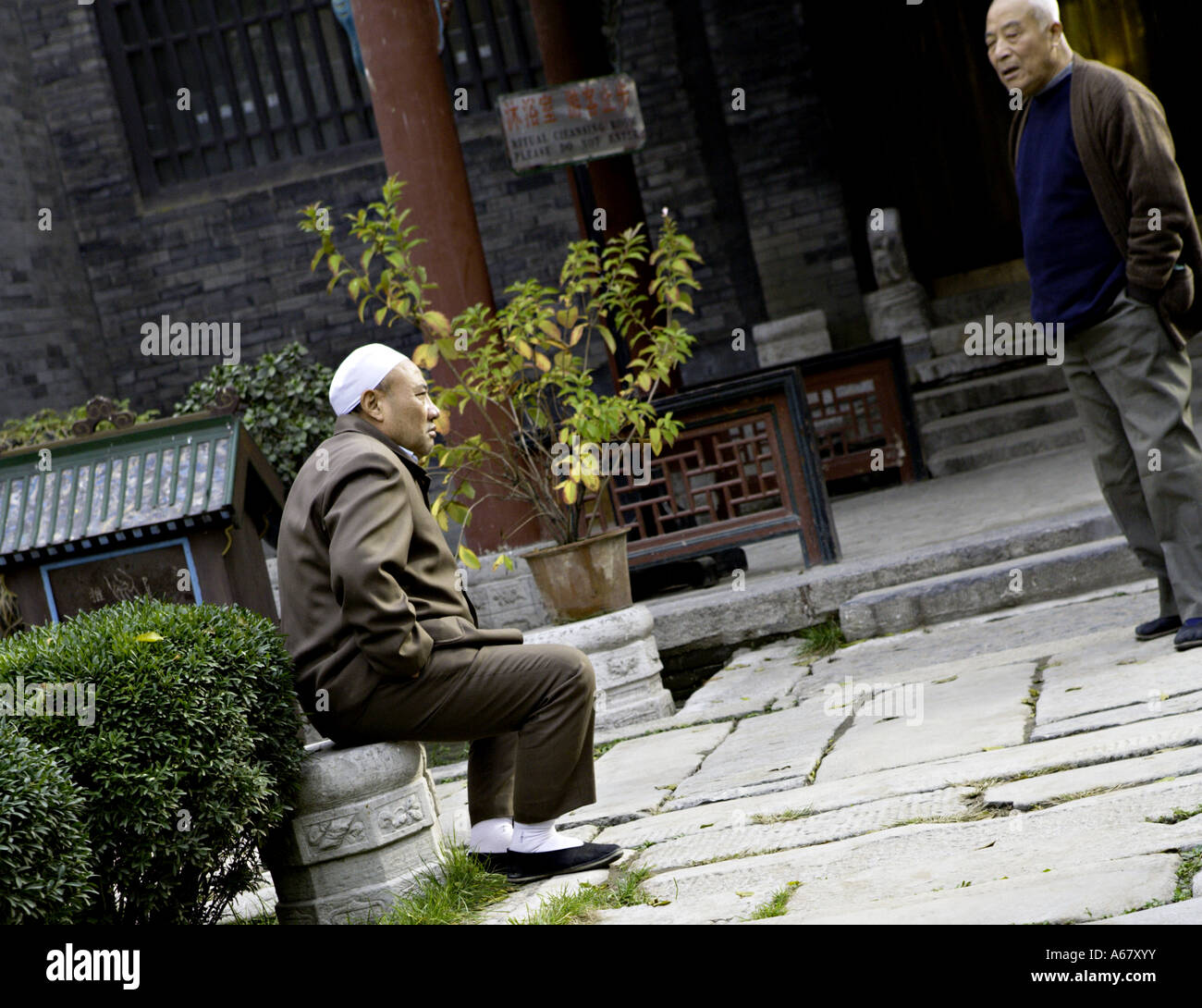 CHINA XIAN Chinese Muslim men talking as they wait at the Great Mosque ...
