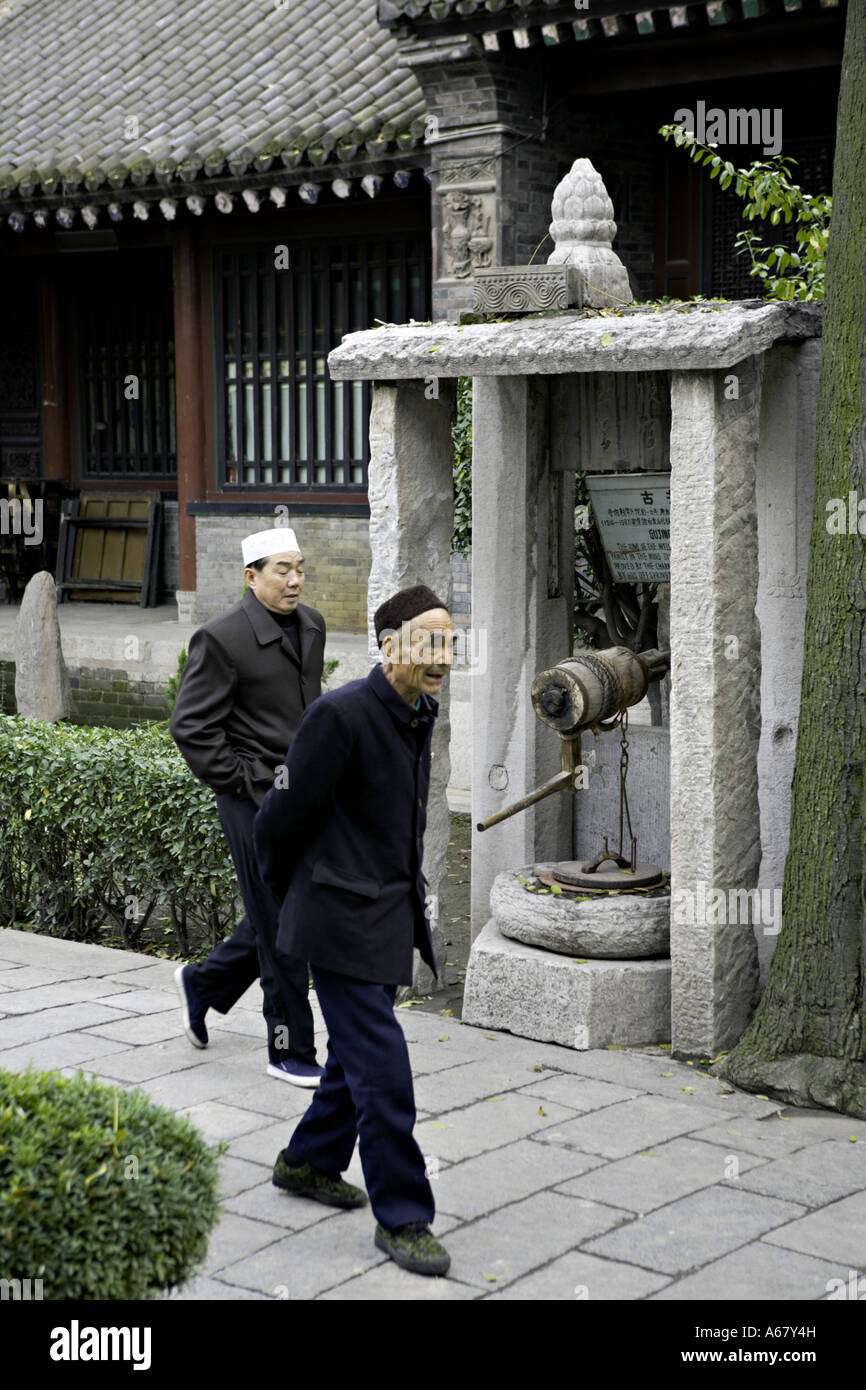 CHINA XIAN Chinese Muslim men walk past an ancient well in the ...