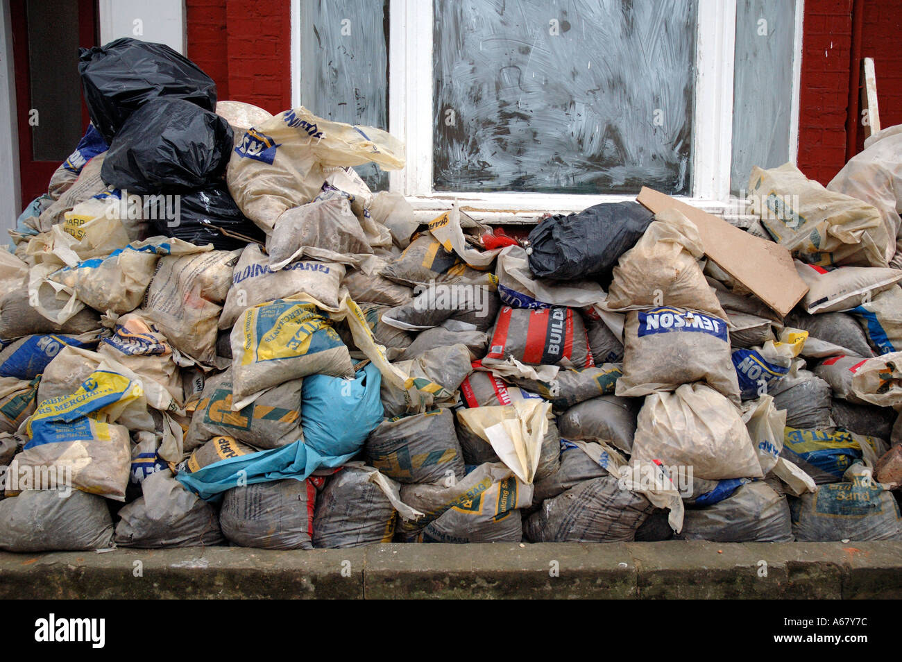 Sold house being renovated by builders with sakes of rubble lined up ...