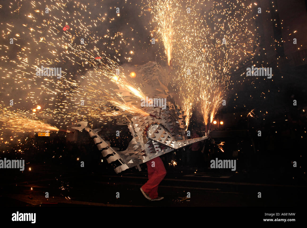 Fallero wearing dragon costume with torches parades in the Cavalcada ...