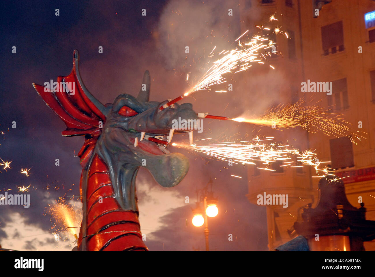 Fallero wearing dragon costume with torches parades in the Cavalcada ...