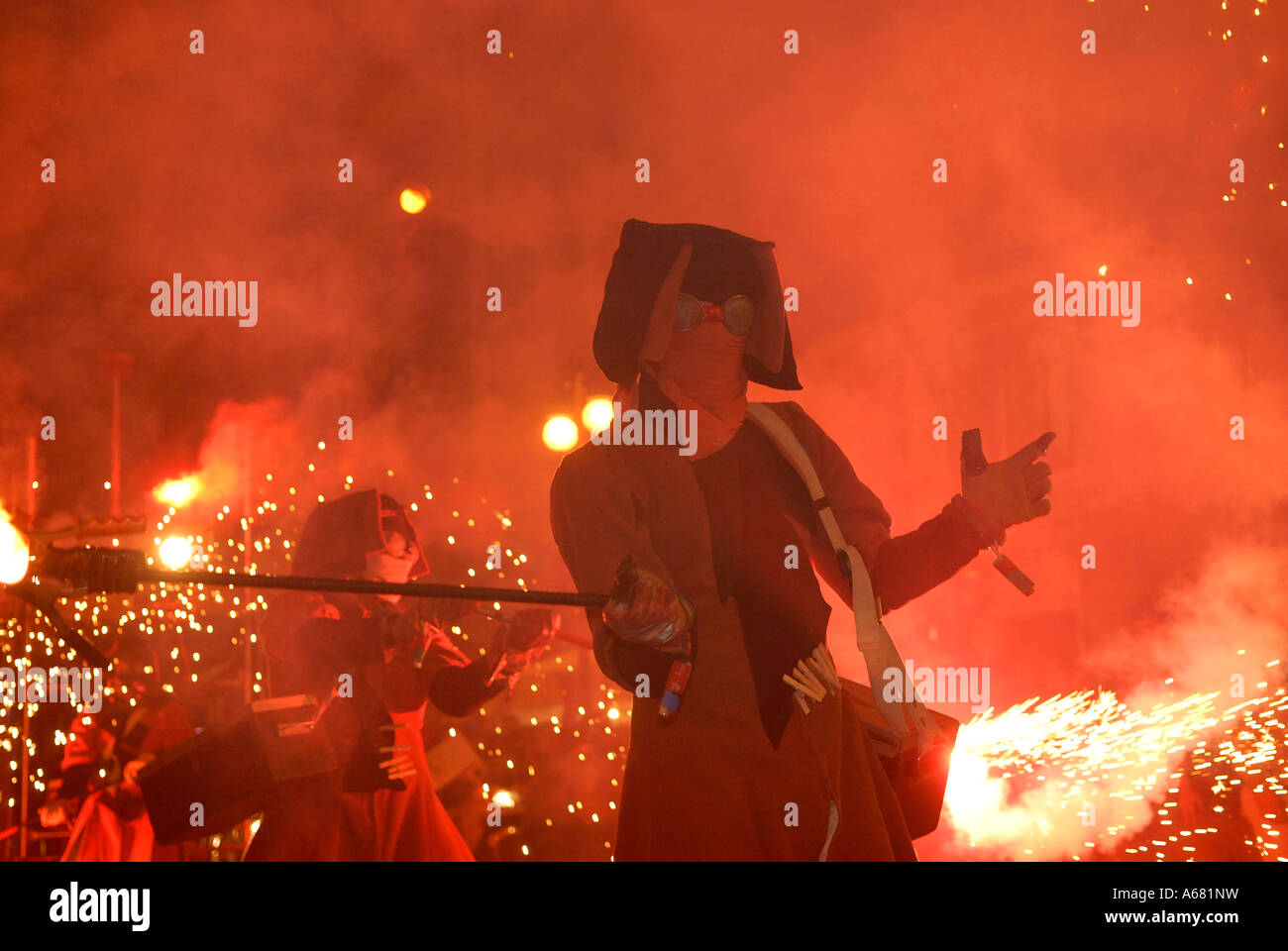 Fallers, throwing large firecrackers in the street as they go during ...