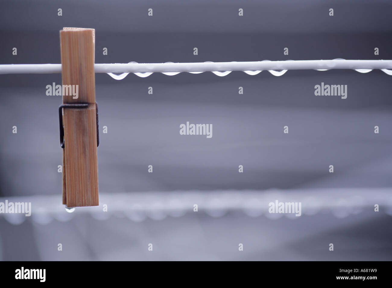 Clothes peg on washing line in the rain Stock Photo - Alamy