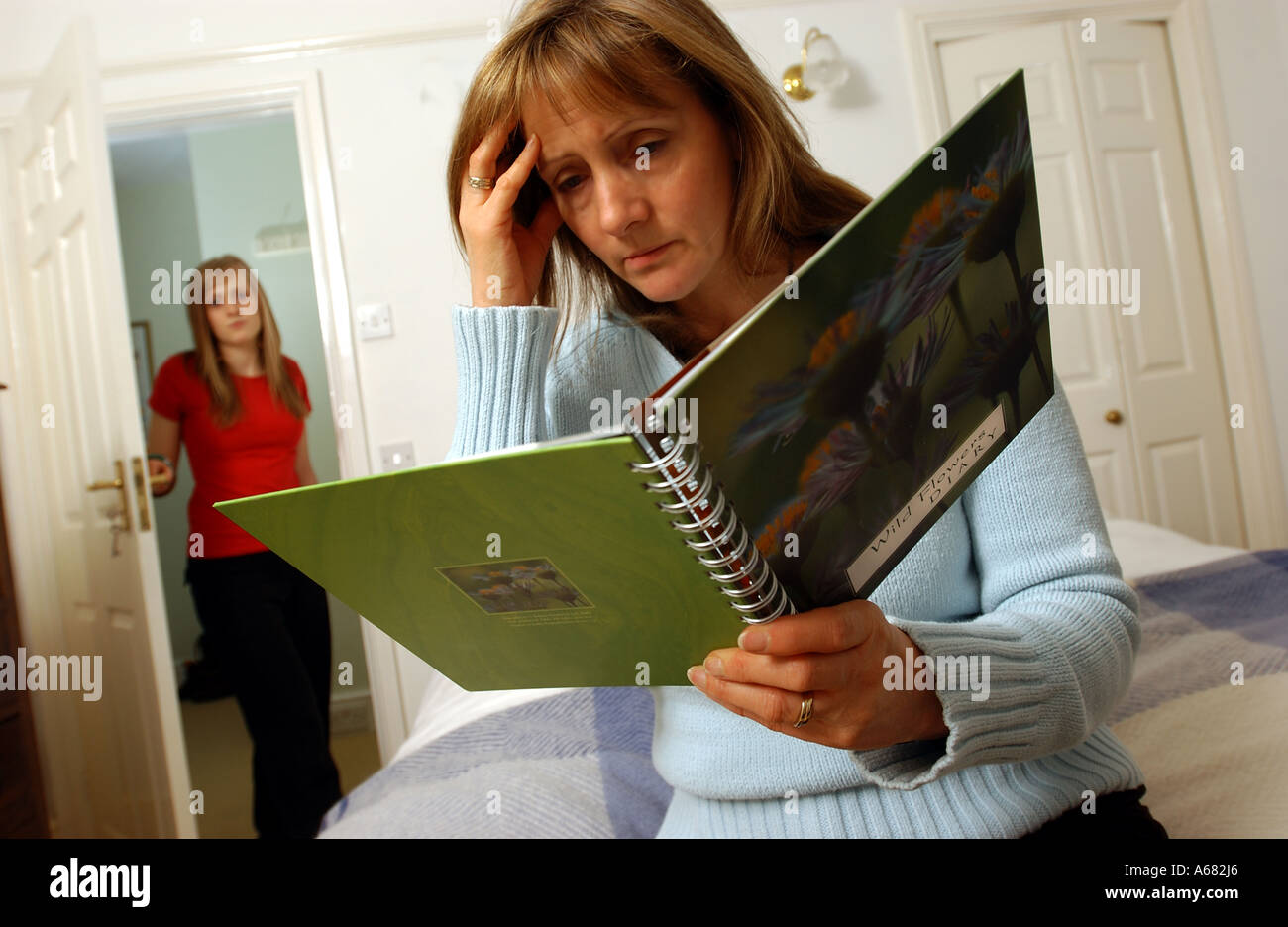 mother reading teenage daughter's diary Stock Photo - Alamy