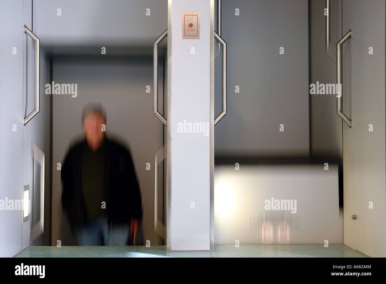Man in vertical lift Stock Photo - Alamy