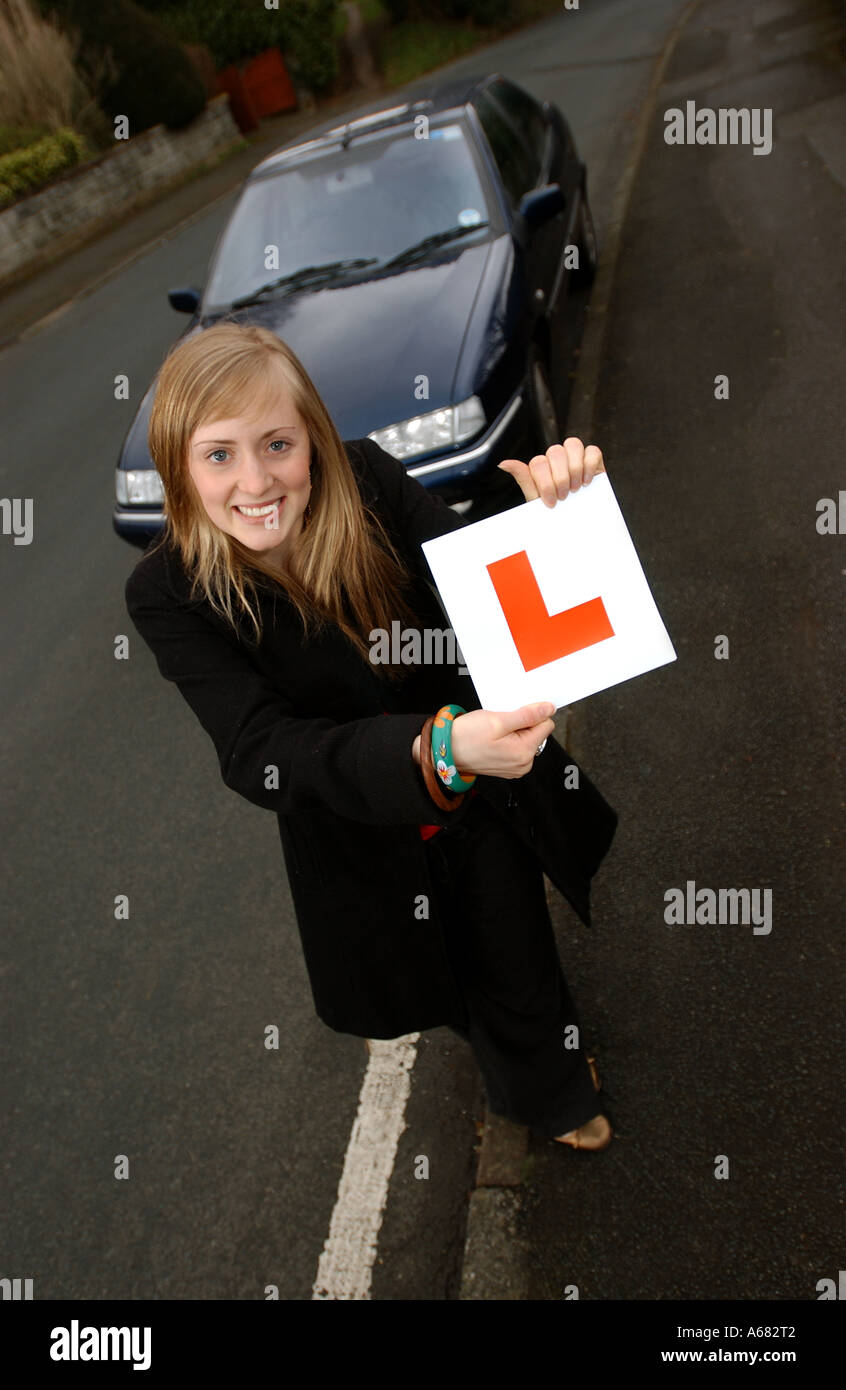 Young woman learner driver with L plates Stock Photo - Alamy