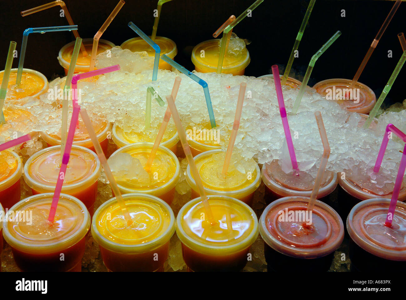 Fresh cold fruit juice served in disposable plastic glass in Mercat de ...
