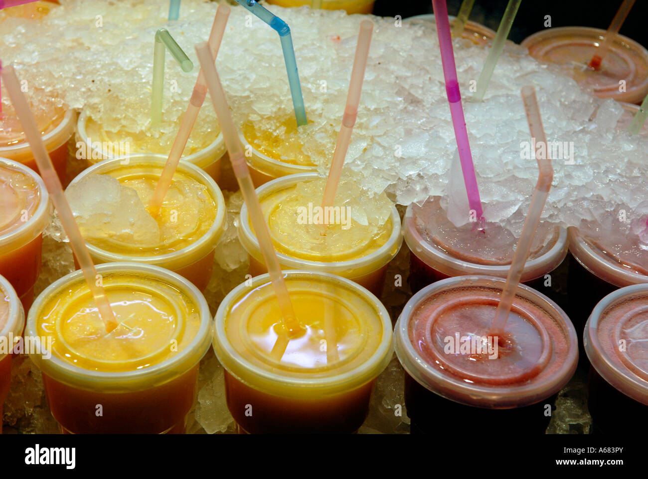 Fresh cold fruit juice served in disposable plastic glass in Mercat de ...