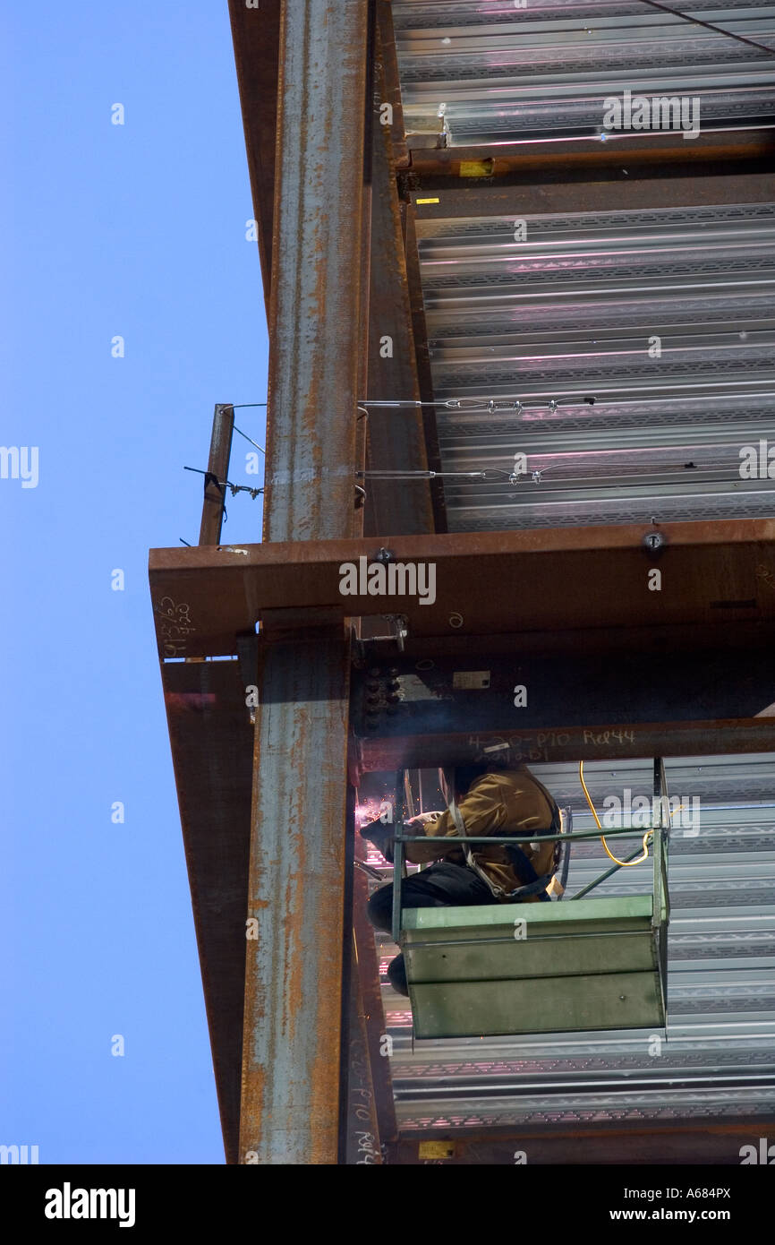 Man welding steel support on high rise building Stock Photo - Alamy