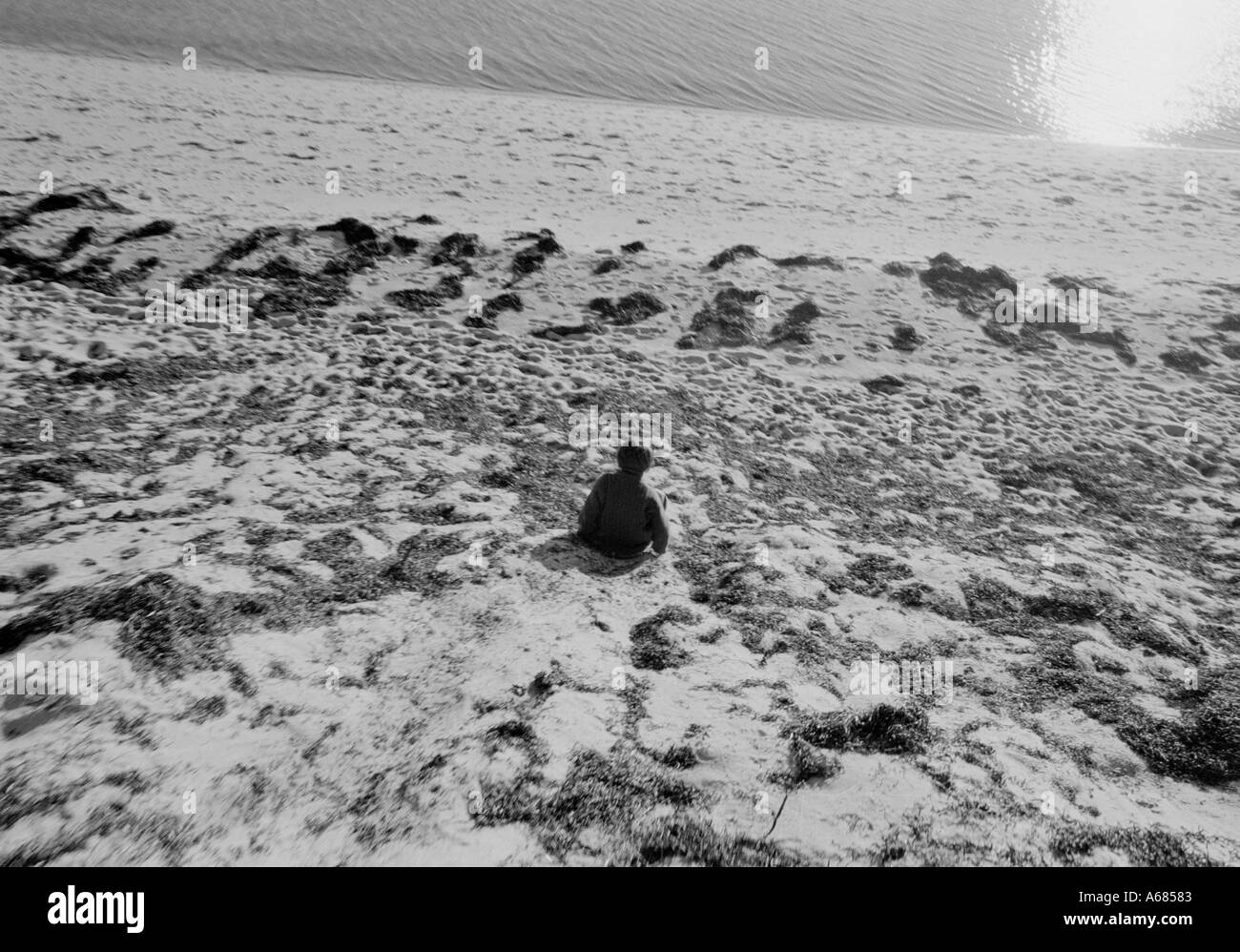 Alone on a beach at sunset Black and White Stock Photos & Images - Alamy