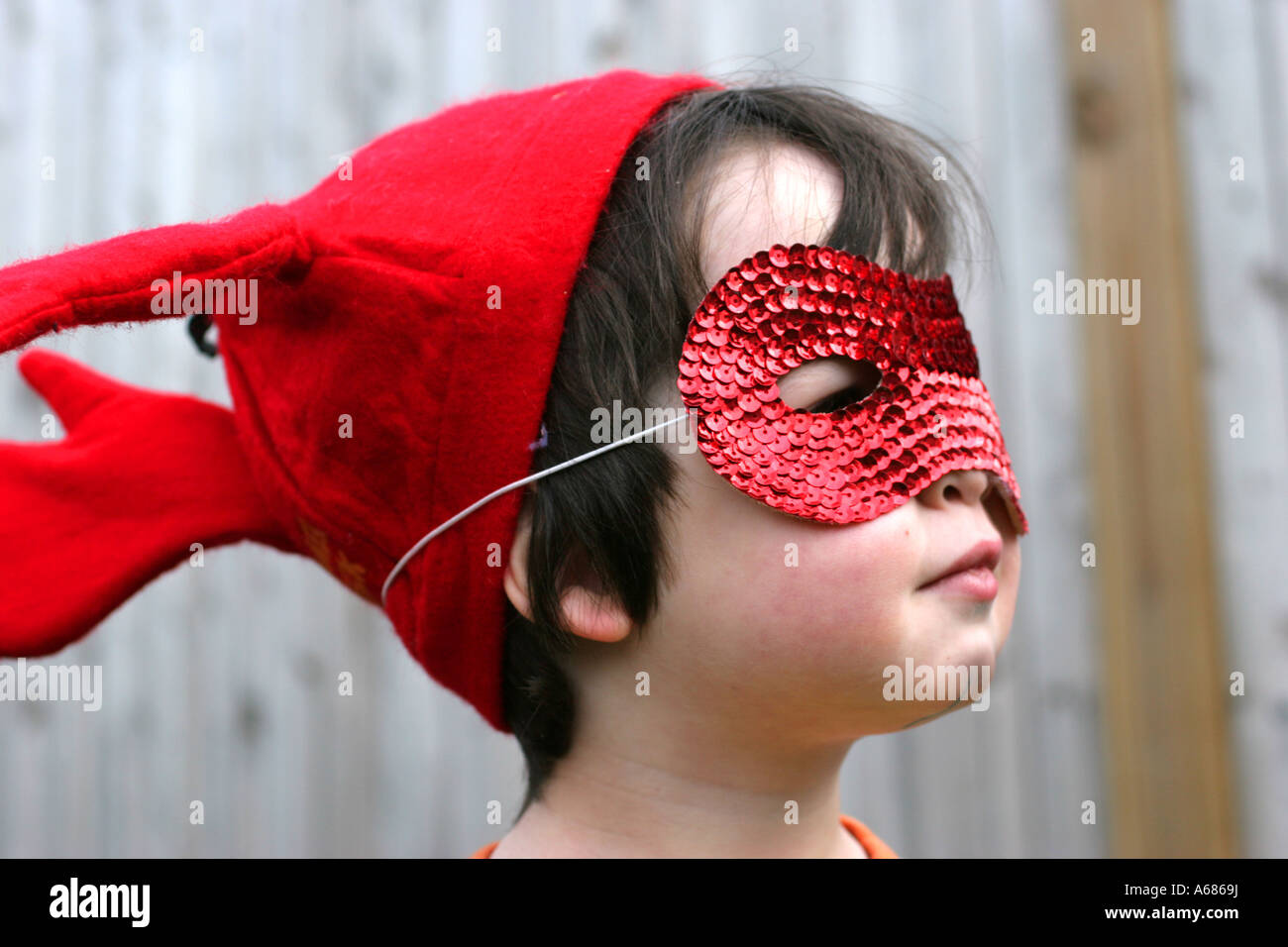 Profile of a boy (3-4 years old) wearing a red mask and hat Stock Photo ...