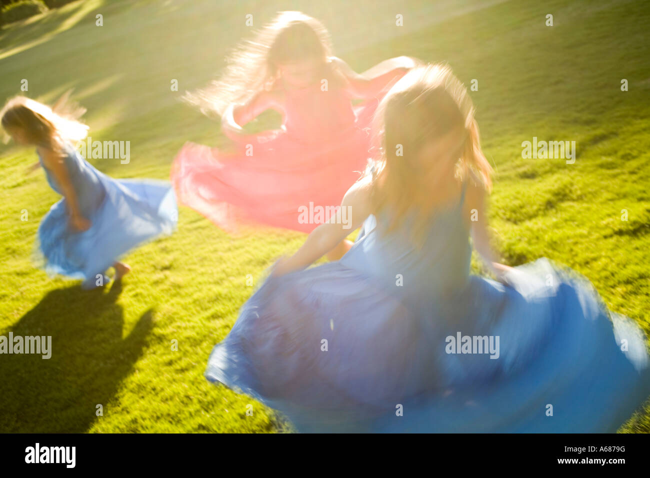 Three girls outdoors spinning Stock Photo - Alamy