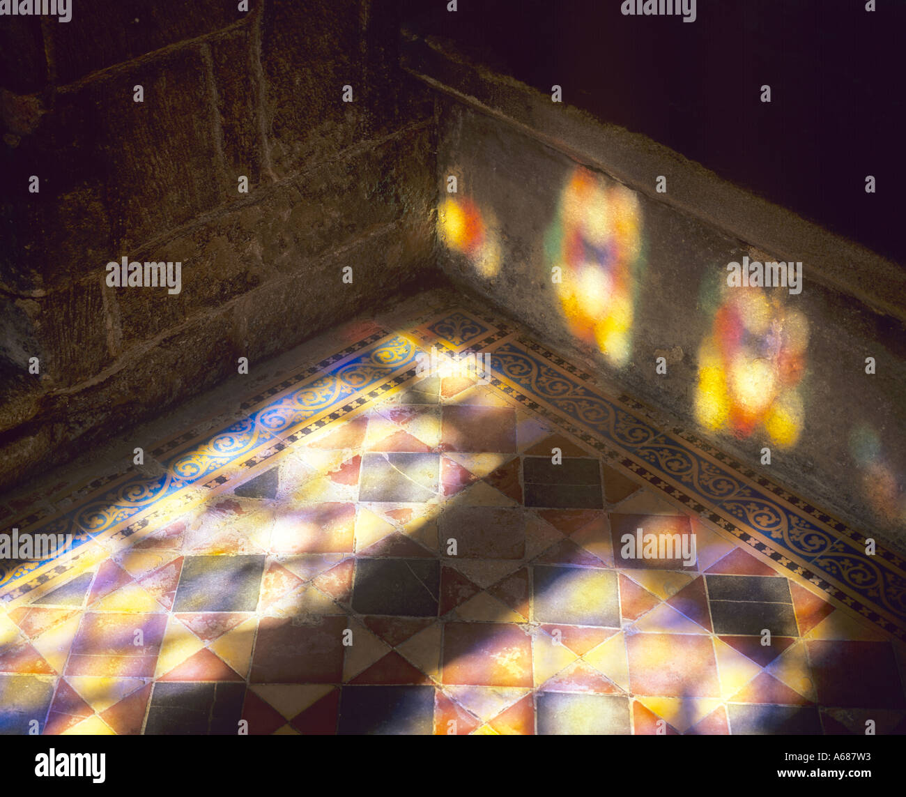 Light streams through a stained glass window at Tynemouth Priory's ...