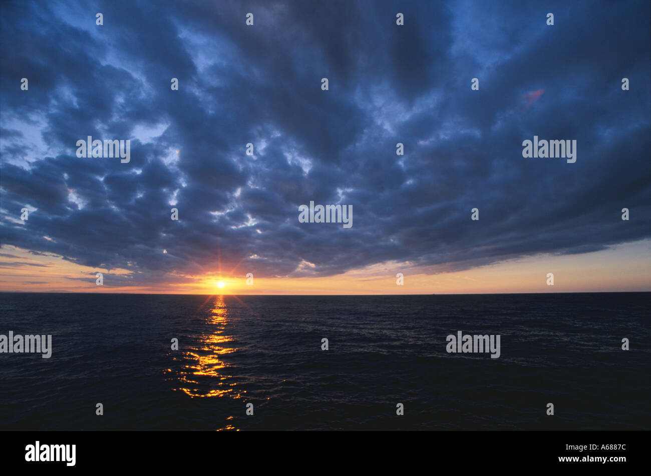 Sunrise in open sea Stock Photo - Alamy
