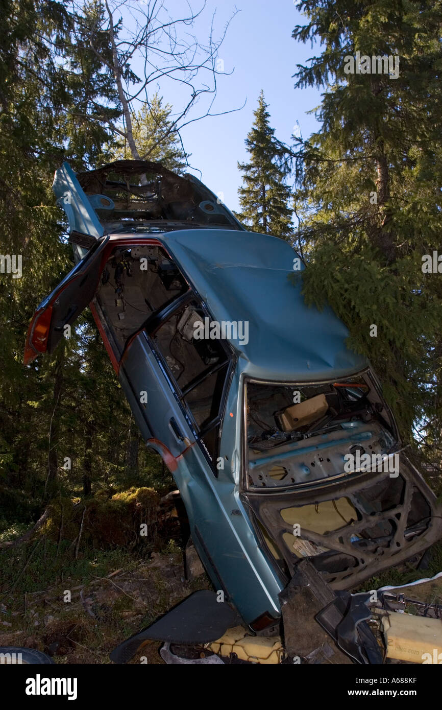 Ripped car frame leaning to tree in forest , Finland Stock Photo - Alamy