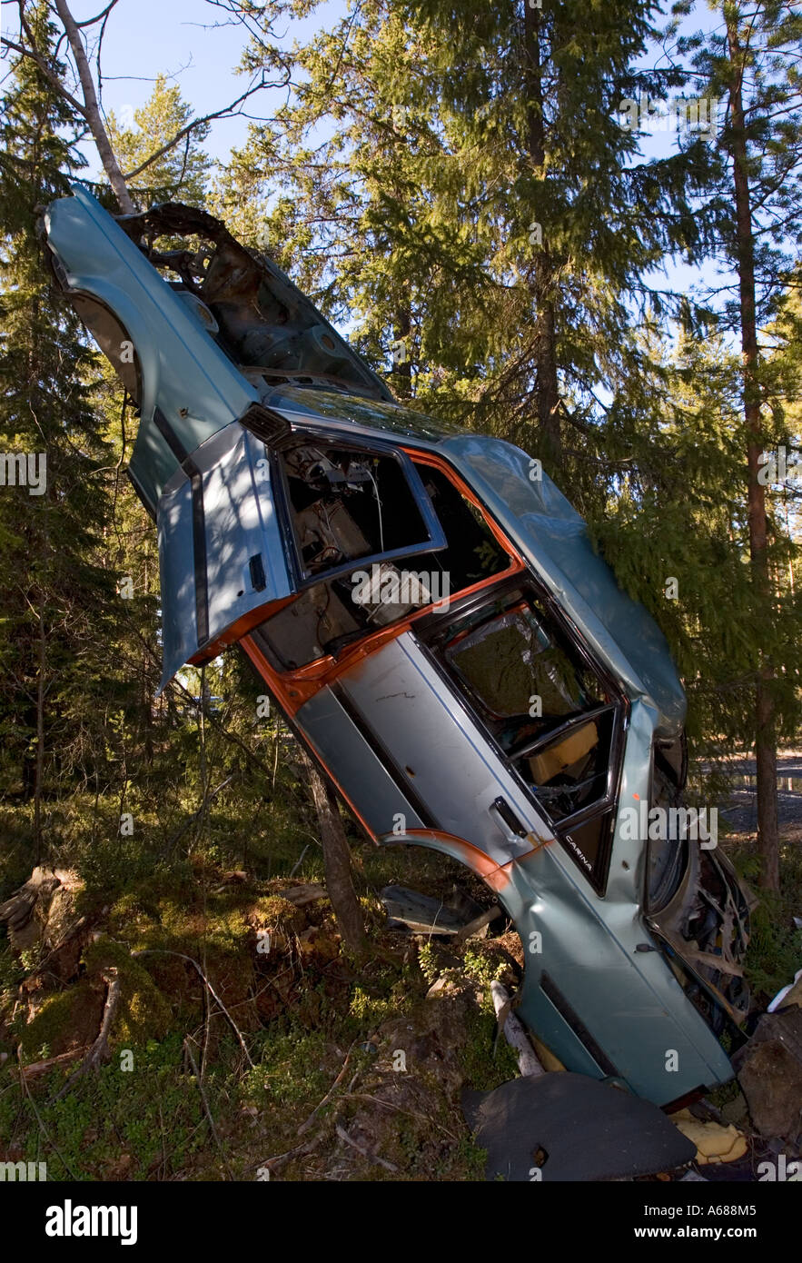 Ripped car frame leaning to tree in forest , Finland Stock Photo - Alamy