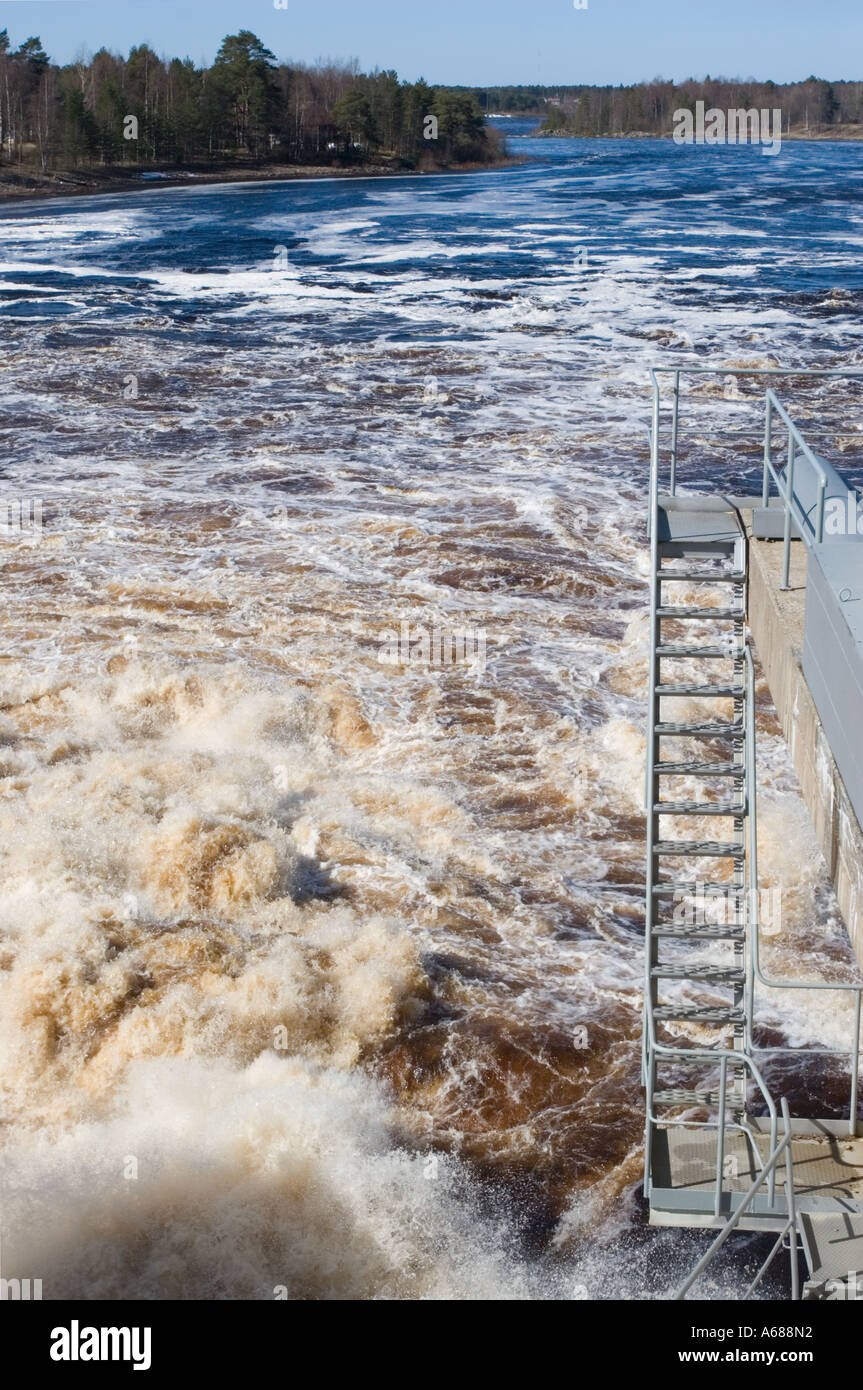 Metal ladders over roiling water which discharges from hydroelectric ...