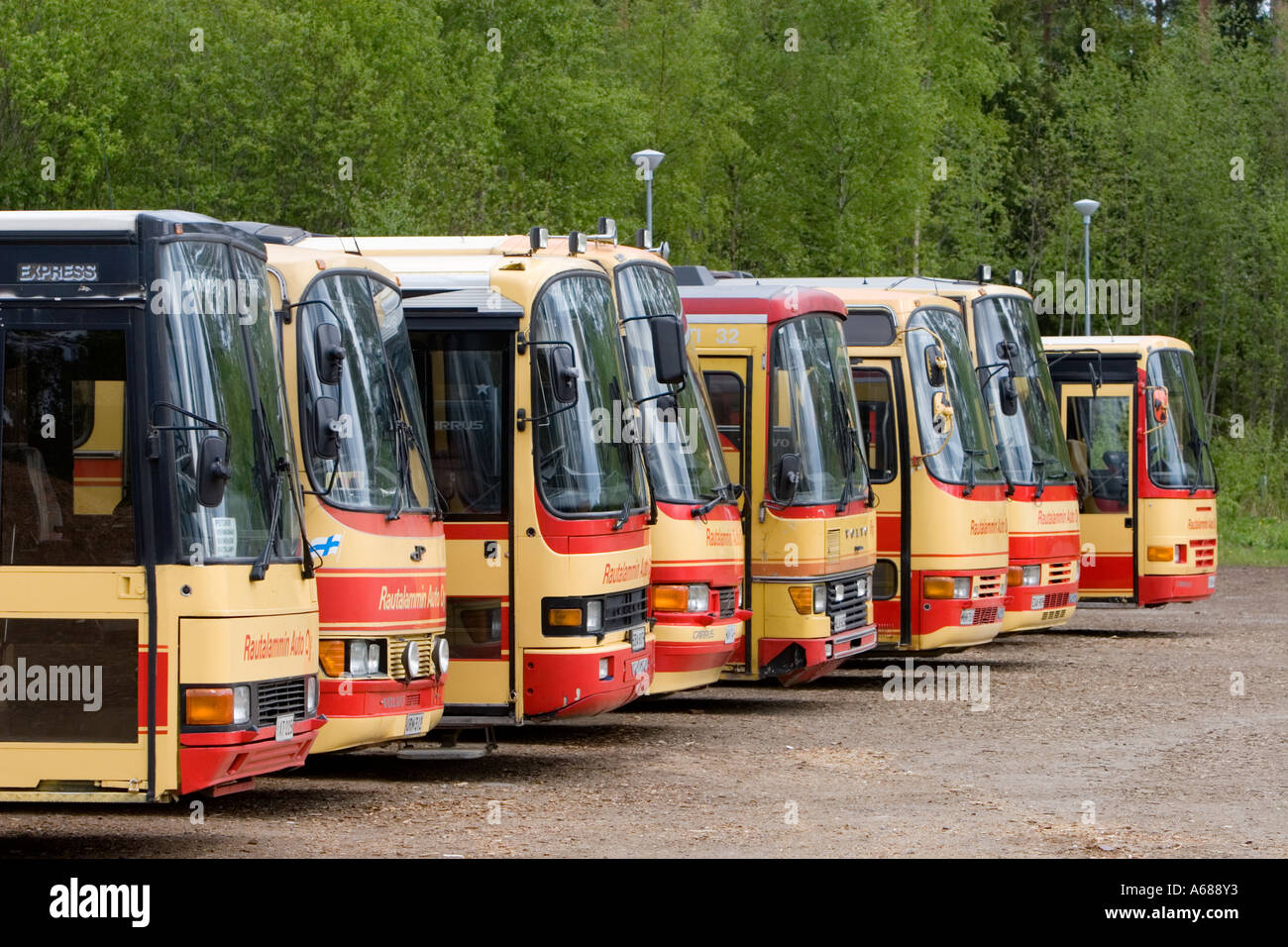 Line-up of parked bright red and yellow colored buses in Finland Stock ...