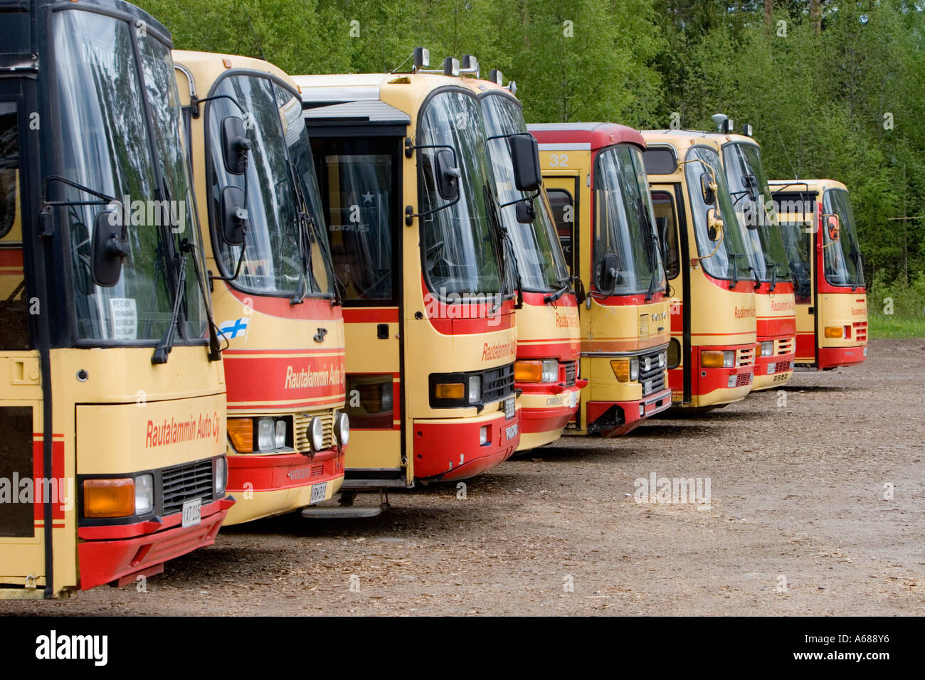 Line-up of parked bright red and yellow colored buses in Finland Stock ...