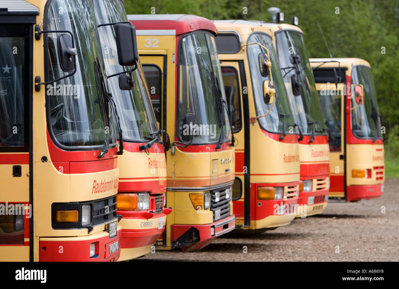 Line-up of parked bright red and yellow colored buses , Finland Stock ...