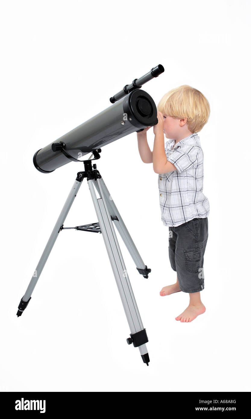 Young child or boy looking through a telescope with white isolated ...
