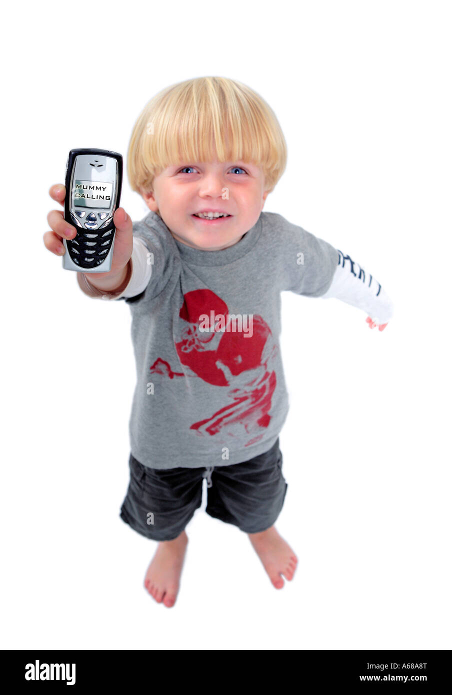 Young boy or child excitedly holding up his mobile phone to show the ...