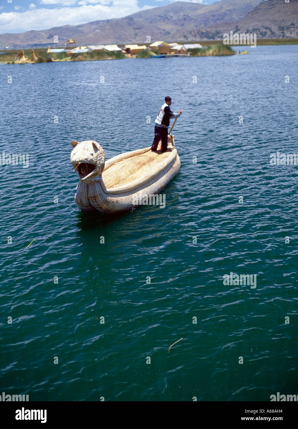 south american indian tribe rowing a boat on inland sea, lake titacaca ...