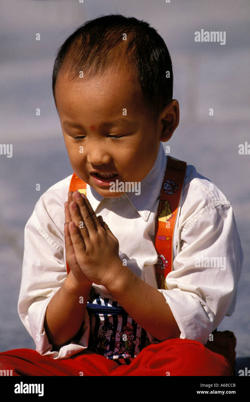 China, Beijing, Young boy with hands folded Stock Photo - Alamy