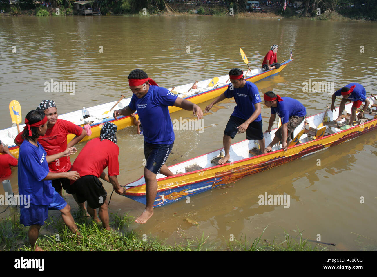 Jumping off a long boat after a rowing competition Stock Photo - Alamy