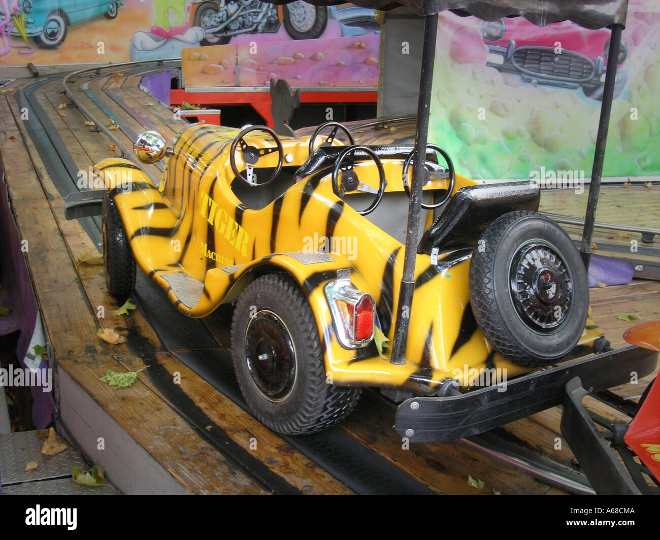 Yellow toy car at fairground ride with double steering Stock Photo - Alamy
