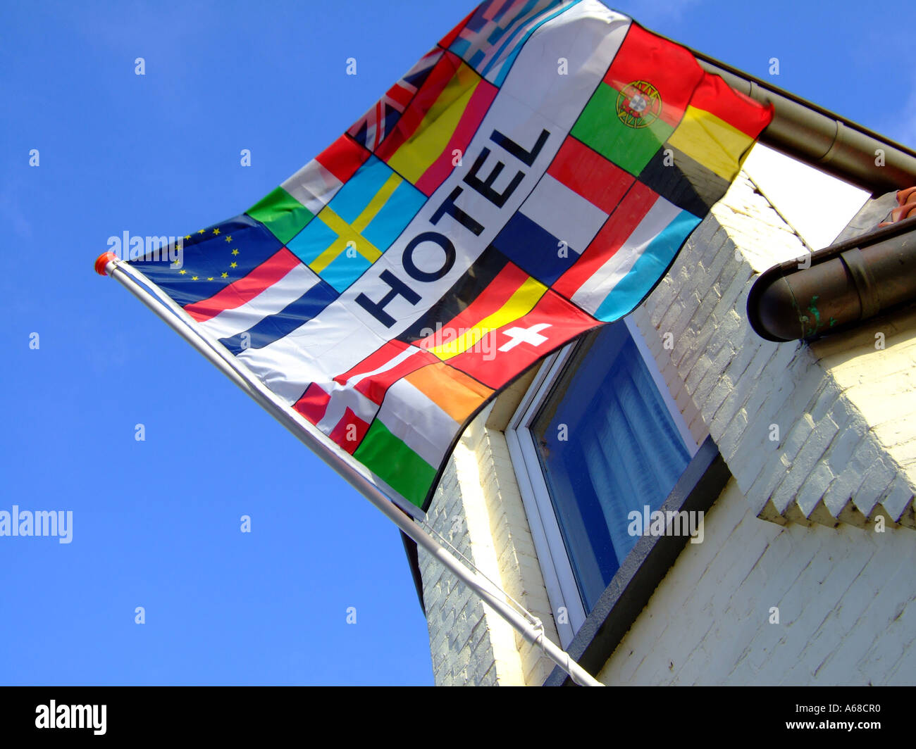 international welcoming flag on pole outside Hotel Stock Photo - Alamy