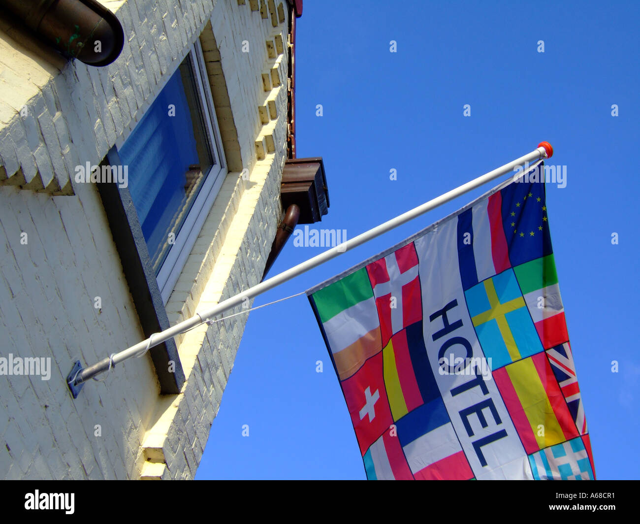 international welcoming flag on pole outside Hotel Stock Photo - Alamy