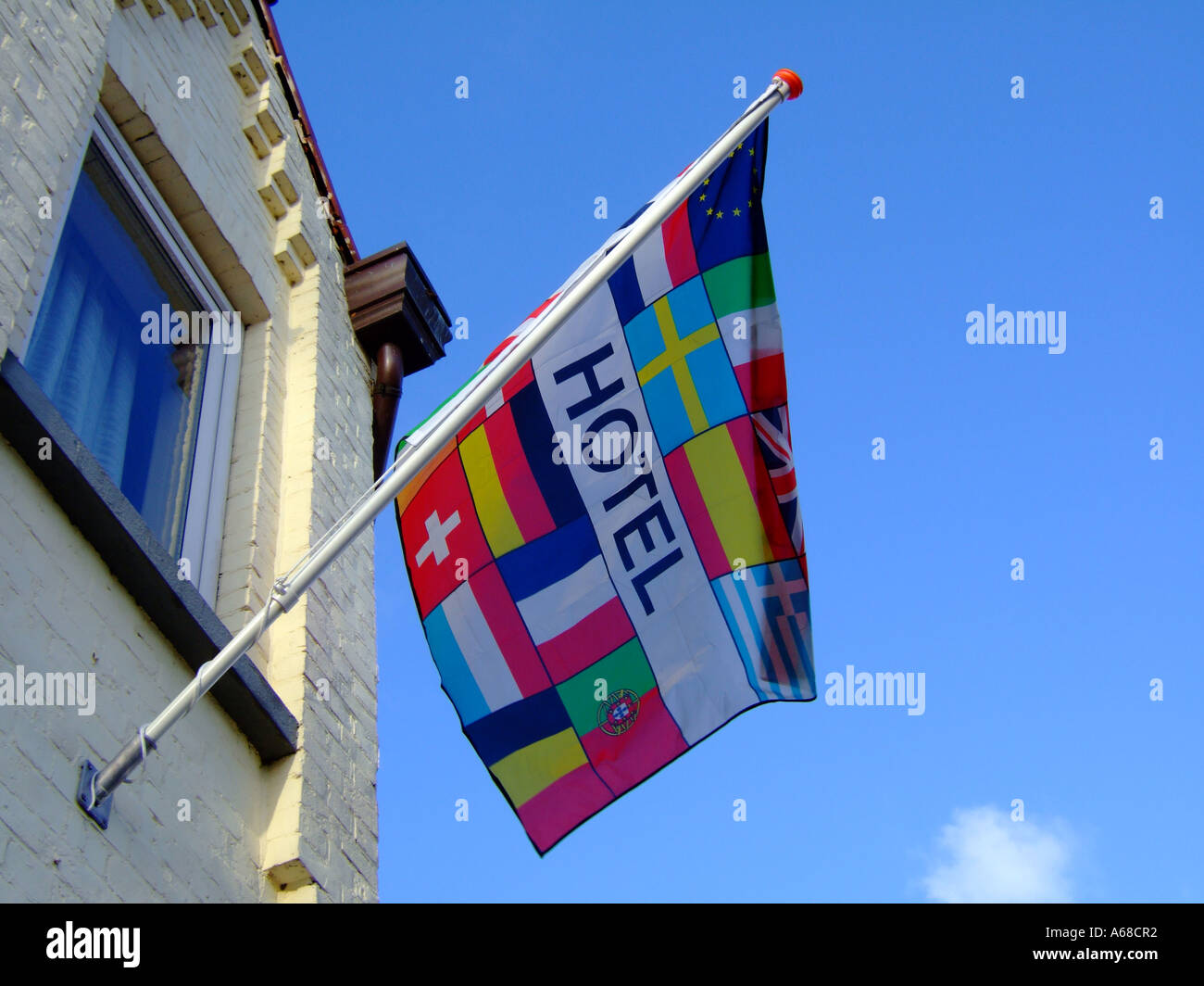 international welcoming flag on pole outside Hotel Stock Photo - Alamy