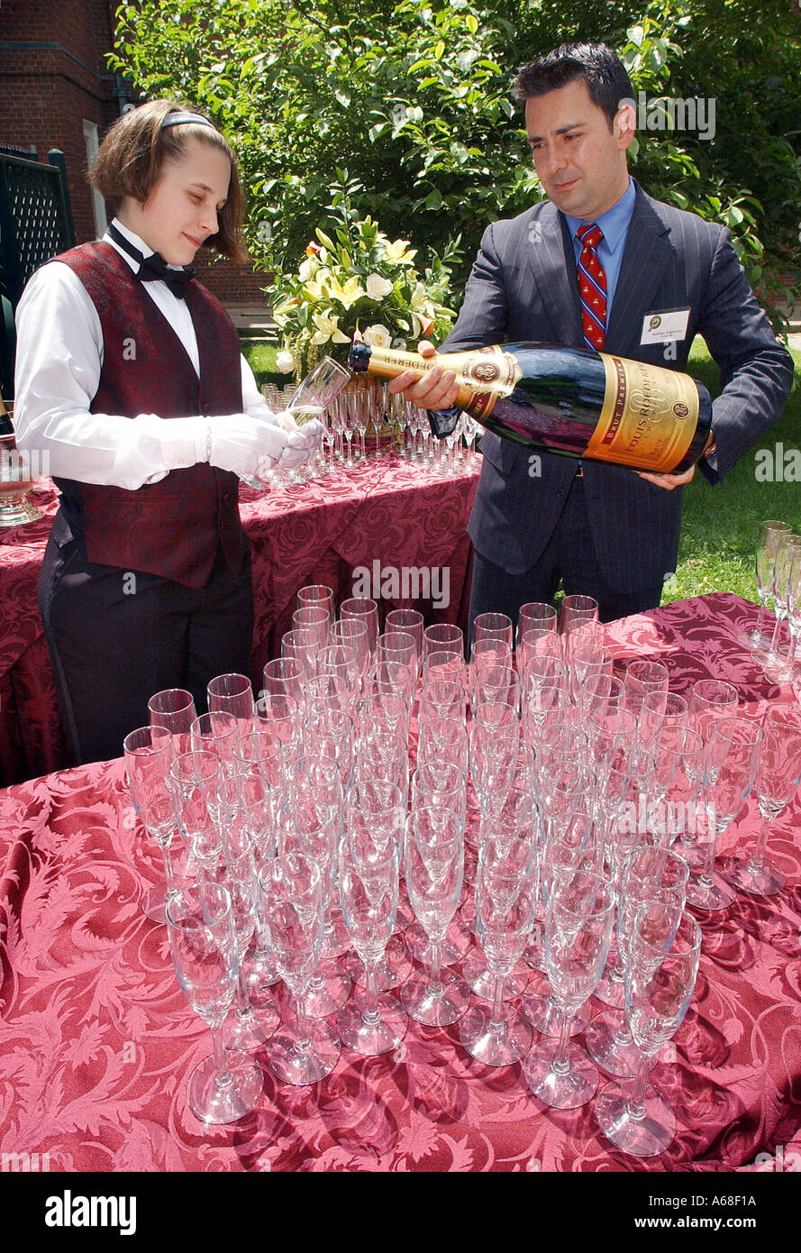 Wait staff pour champagne at an outdoor catered reception Stock Photo ...