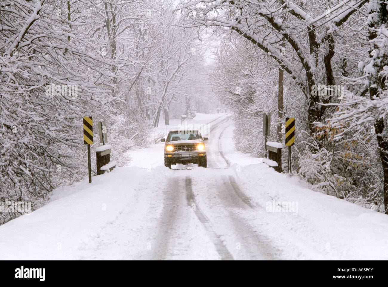 Sports utility vehicle crossing an icy snow covered road Stock Photo ...