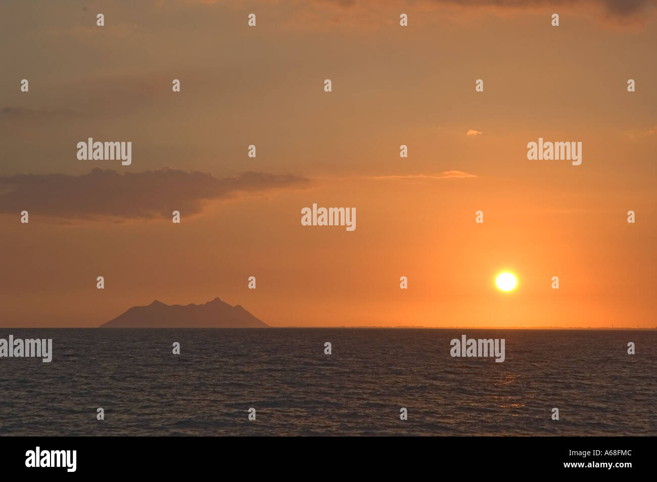 Island on the sunset Stock Photo - Alamy