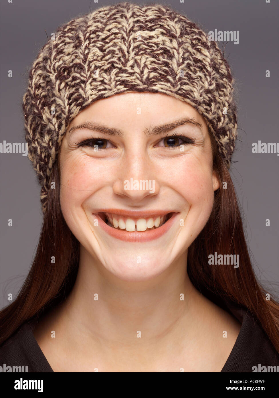 Portrait of a woman with long brunette hair wearing a knitted beret ...