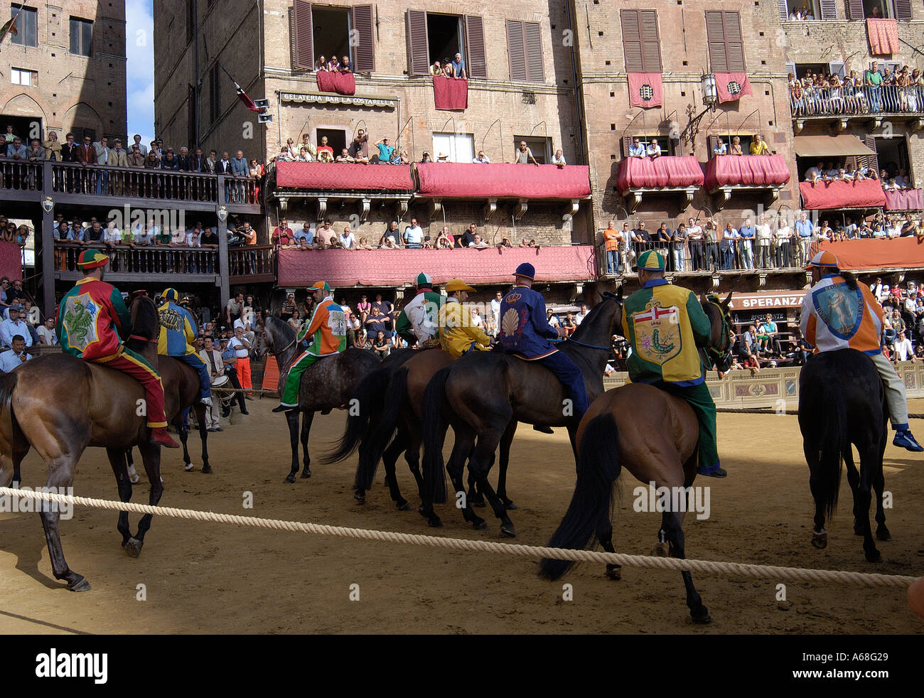 Jockeys dressed in colourful medieval costume line up for the start of ...