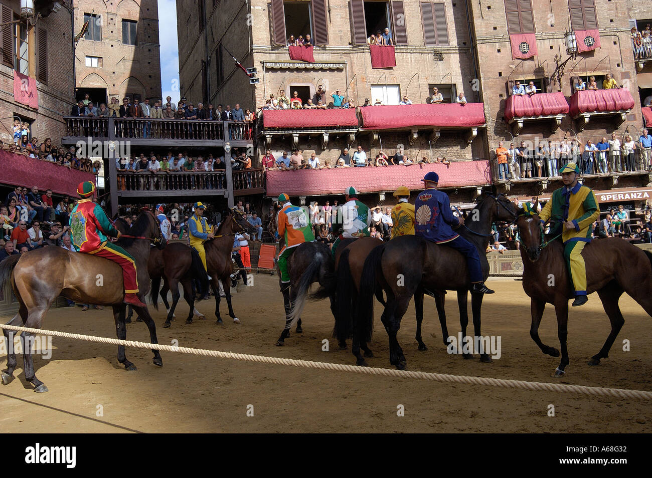 Jockeys dressed in colourful medieval costume line up for the start of ...